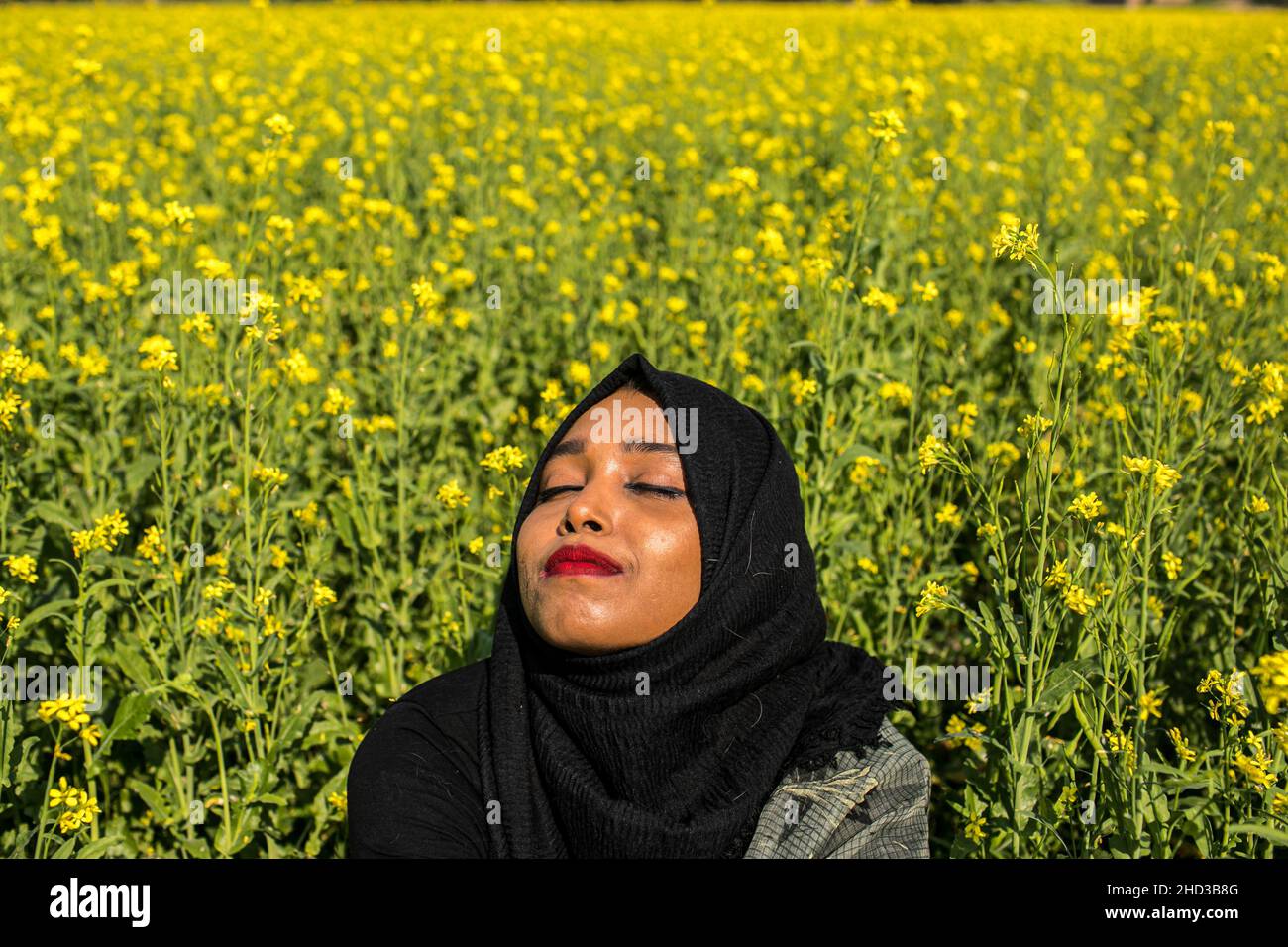 A woman poses for a photo at a yellow Mustard Field on the outskirts of ...