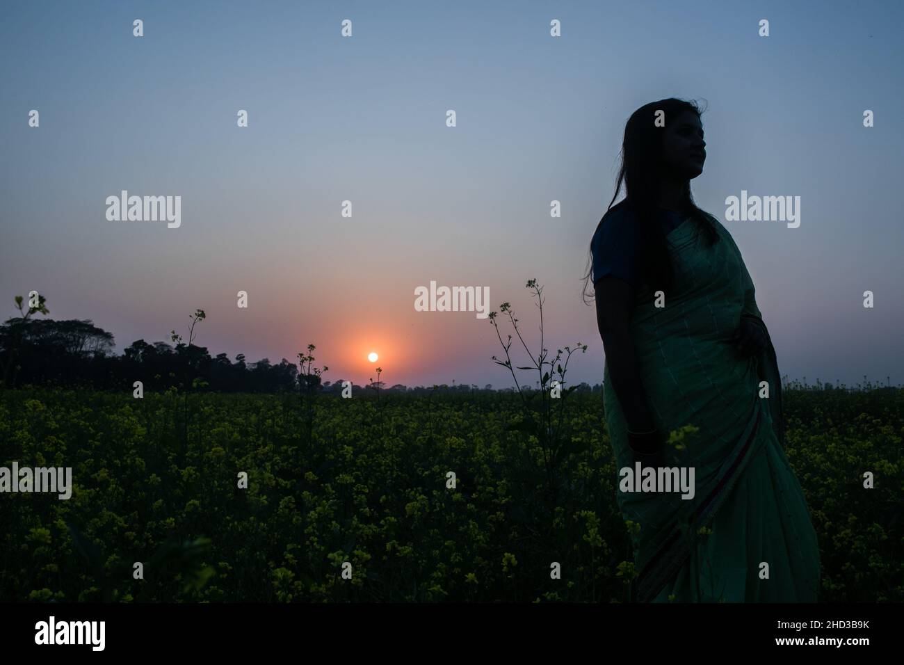 A woman poses for a photo at a yellow Mustard Field on the outskirts of ...