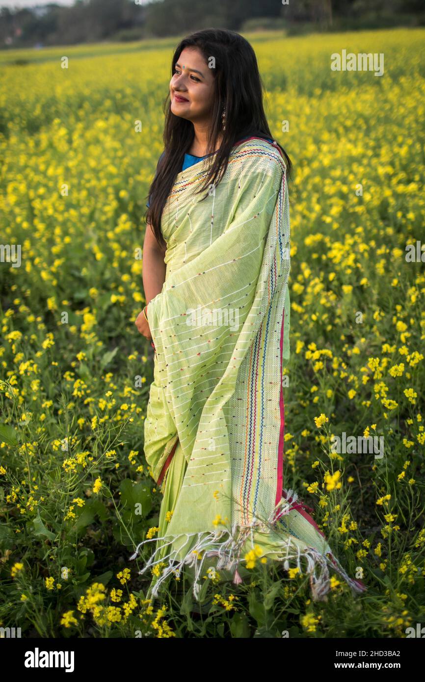 A woman poses for a photo at a yellow Mustard Field on the outskirts of ...