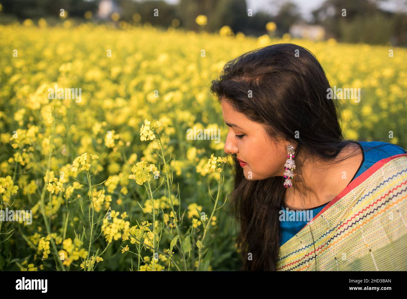A woman poses for a photo at a yellow Mustard Field on the outskirts of Dhaka. Mustard is a cool ...