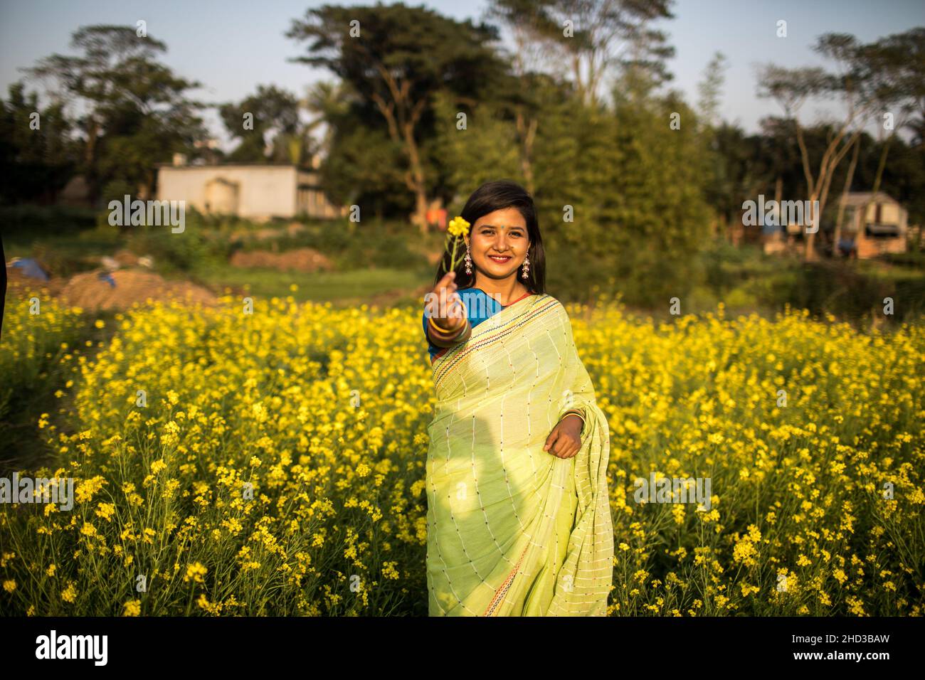 A woman poses for a photo at a yellow Mustard Field on the outskirts of ...