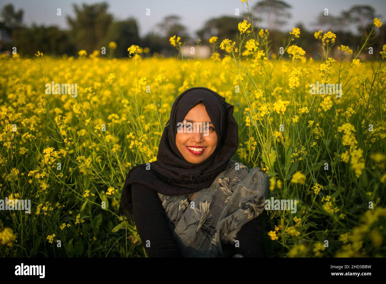 A woman poses for a photo at a yellow Mustard Field on the outskirts of ...