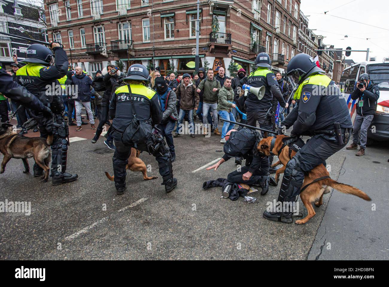 Undercover police officers, and riot police, confront two protesters ...