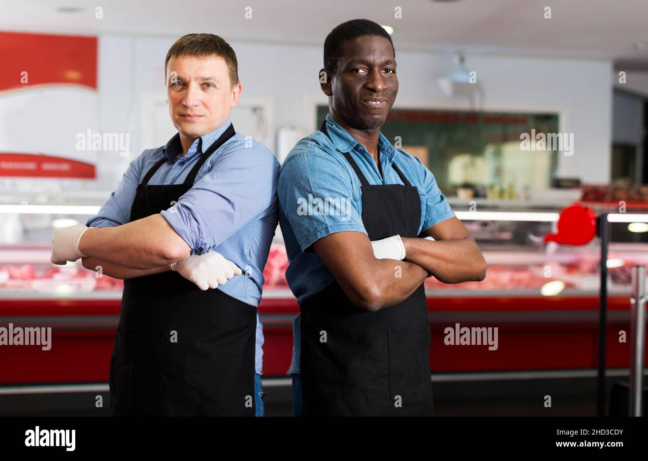 butchers standing in hall of butcher shop Stock Photo - Alamy