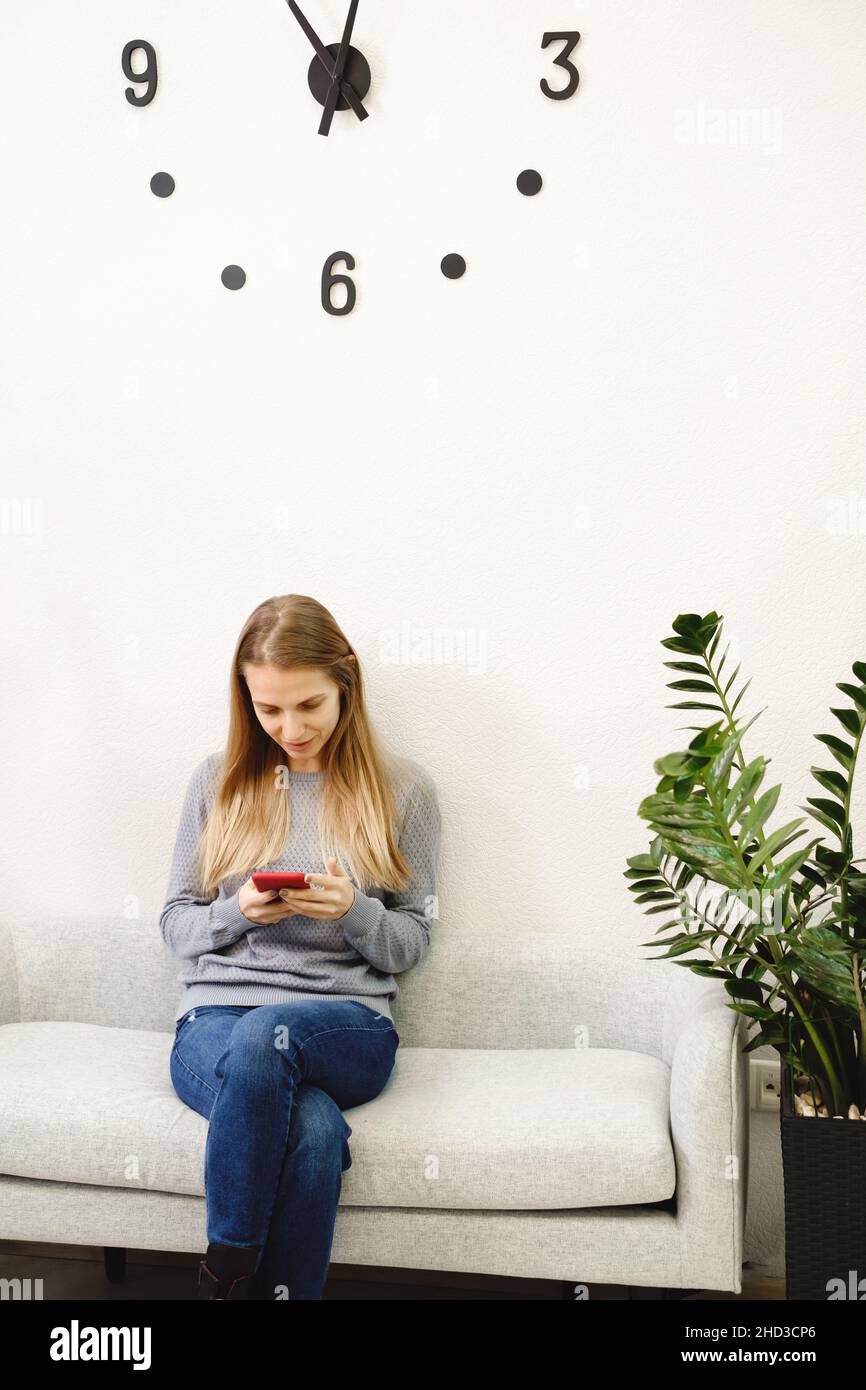 Client is waiting in beauty salon. Woman using smart phone and relax on ...