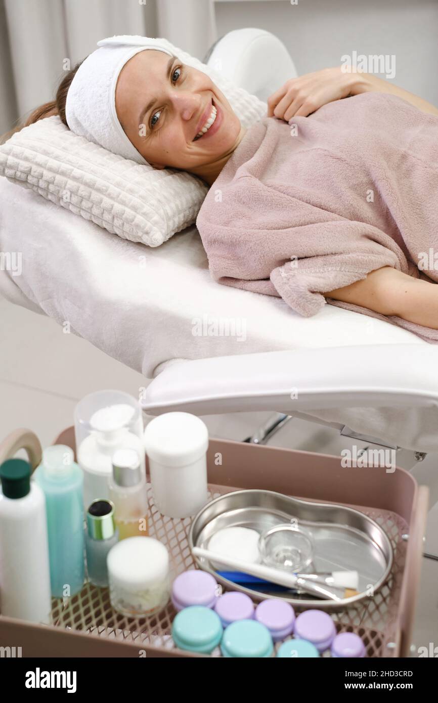 Happy woman at cosmetologist, before care and treatment procedure in ...