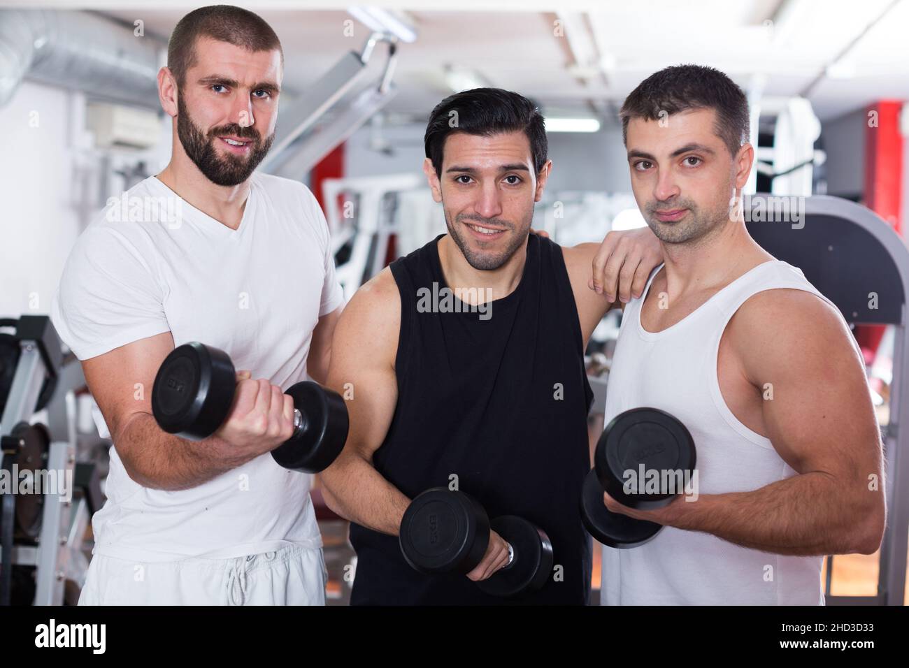 Three men in gym Stock Photo - Alamy