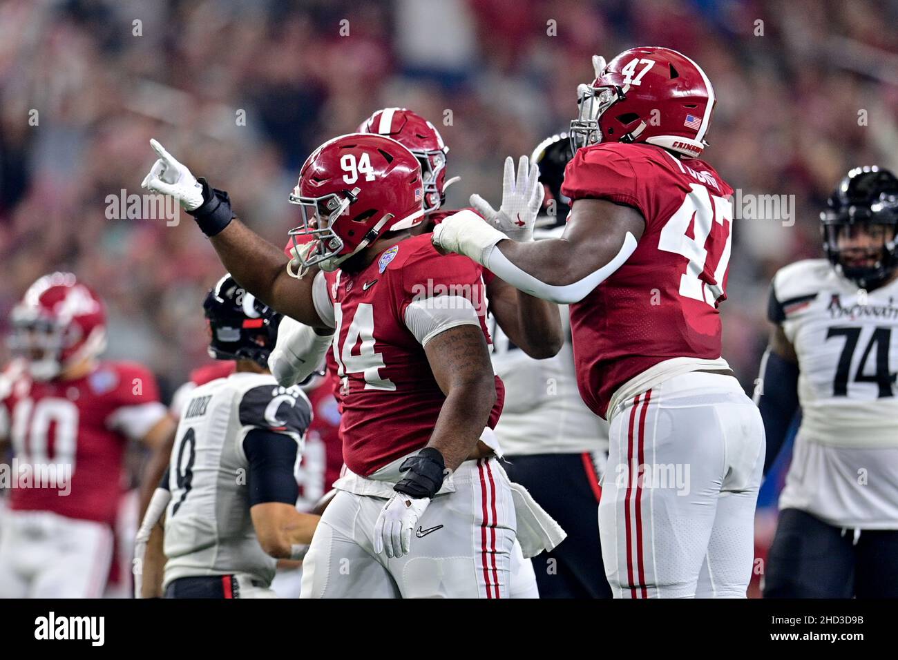 Cincinnati Bearcats quarterback Desmond Ridder (9) is sacked by Alabama ...