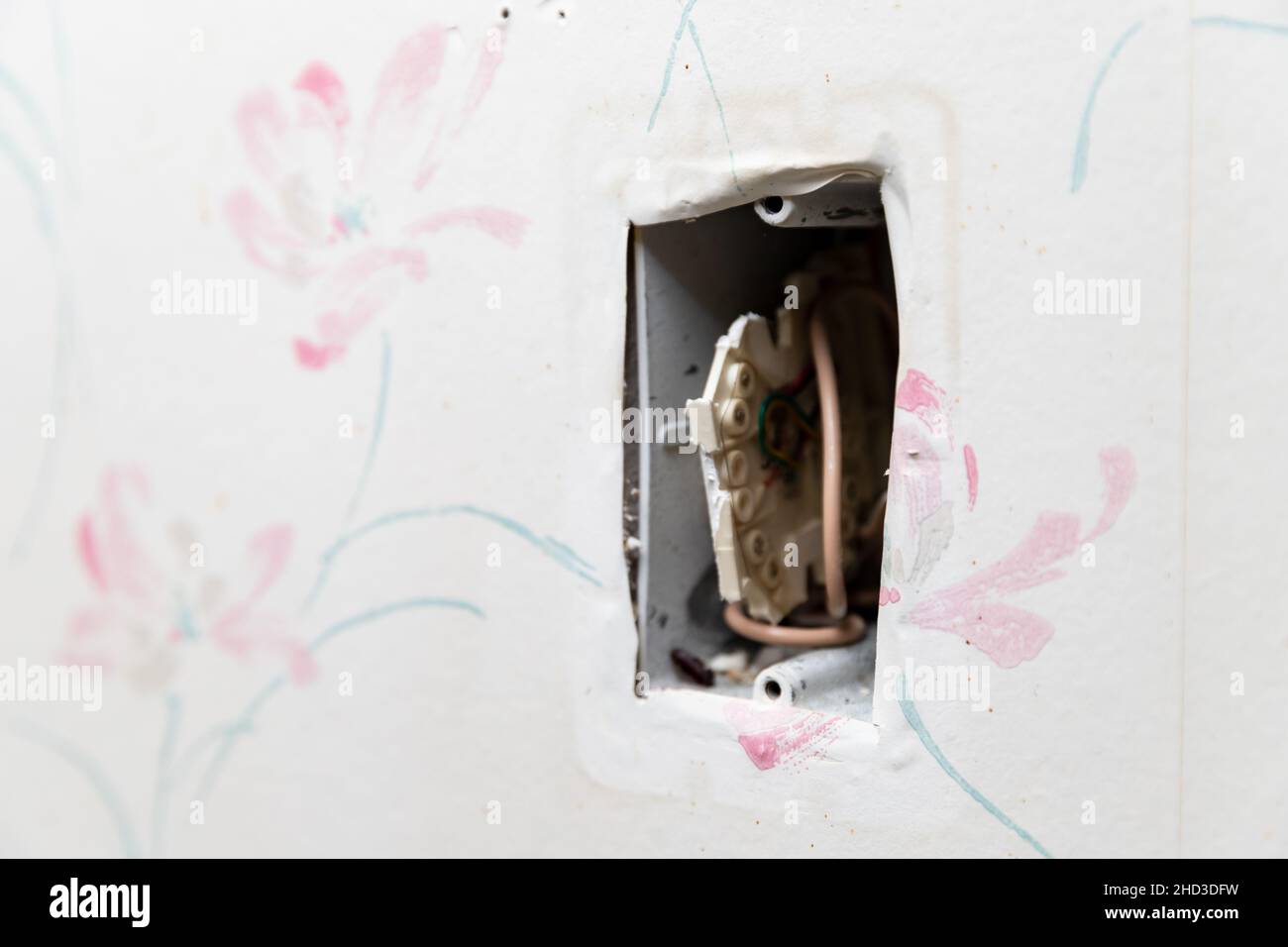 Exposed Electrical outlet on wall creating a safety hazard, selective ...