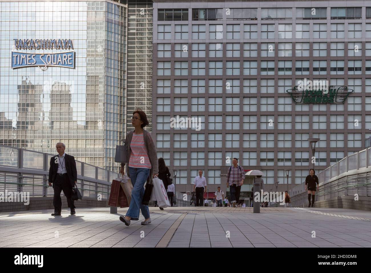 People walk in front of Takashimaya Times Square shopping mall in ...