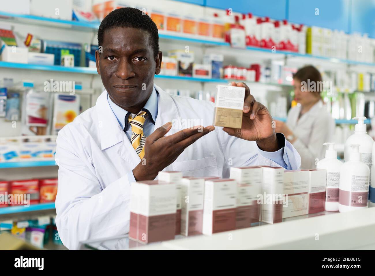 Portrait of experienced male pharmacist counseling about medicines in ...