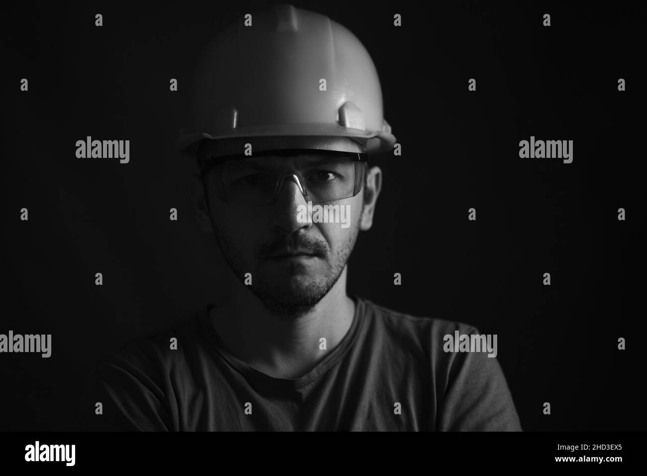 Miner face on black background. Head tired miner in helmet and glasses ...