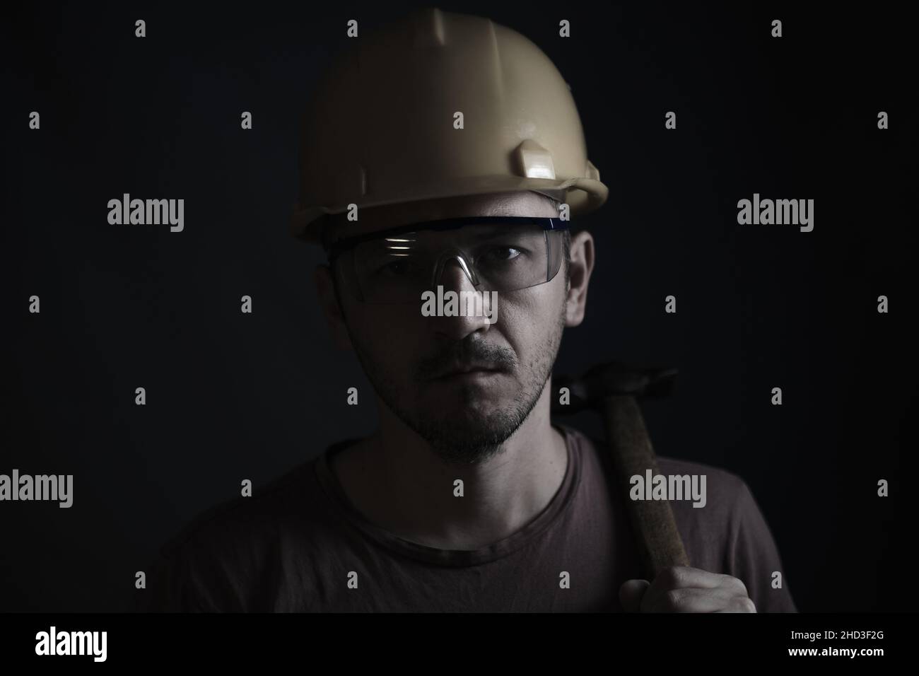Miner face on black background.Head tired miner in helmet and glasses ...
