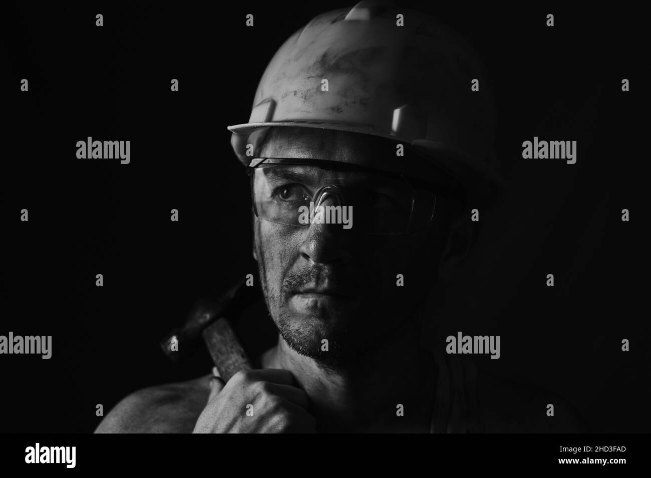 Miner face on black background. Head tired miner in helmet and glasses ...