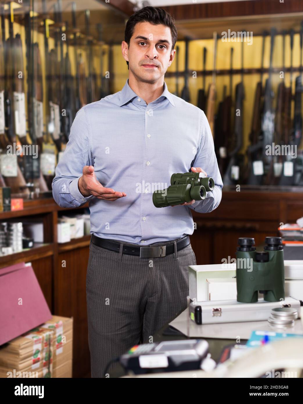 Salesman offering accessories for hunt Stock Photo - Alamy