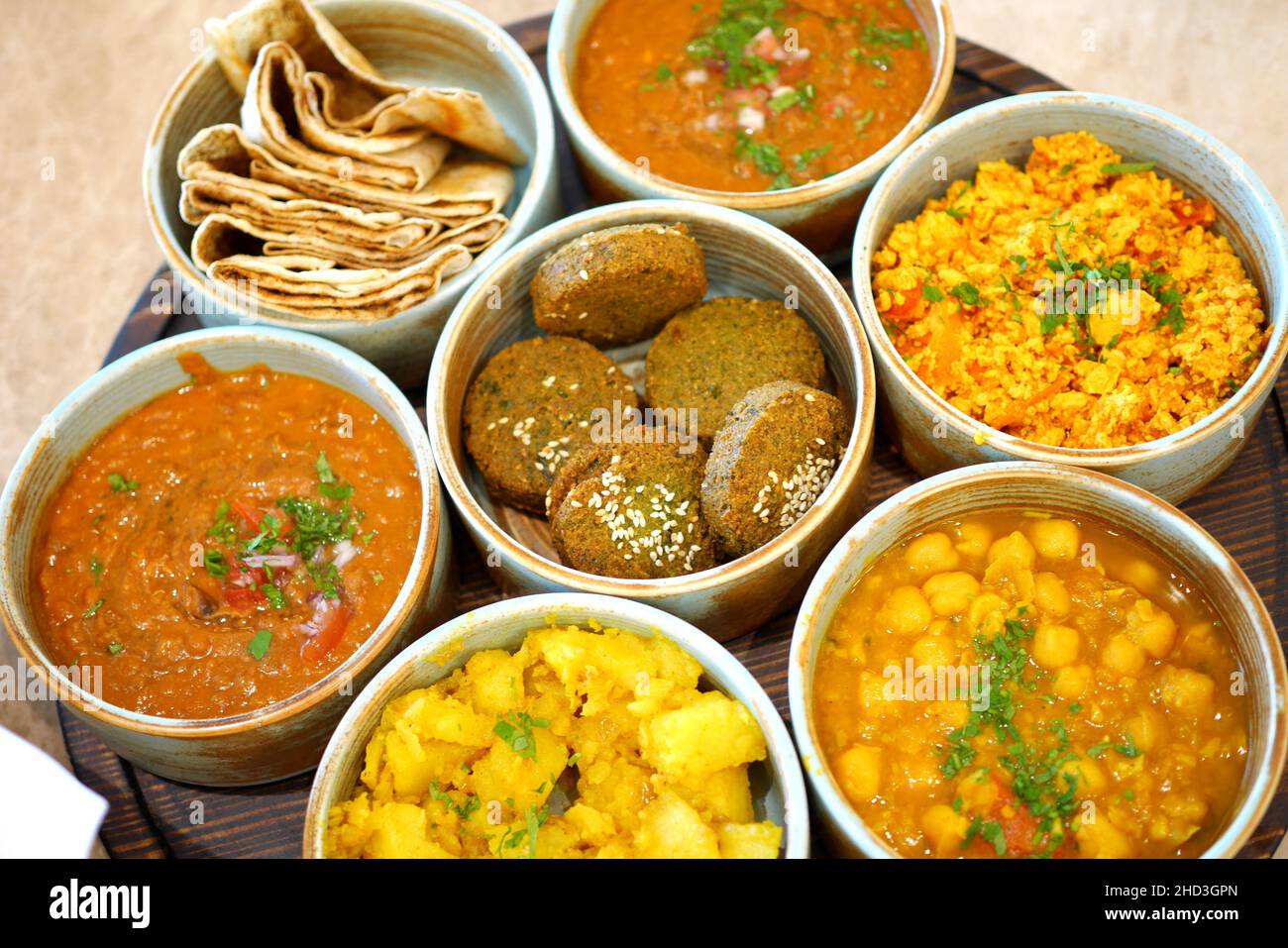 Bahrain breakfast of flat bread, foul medames, eggs, chickpeas, falafel ...