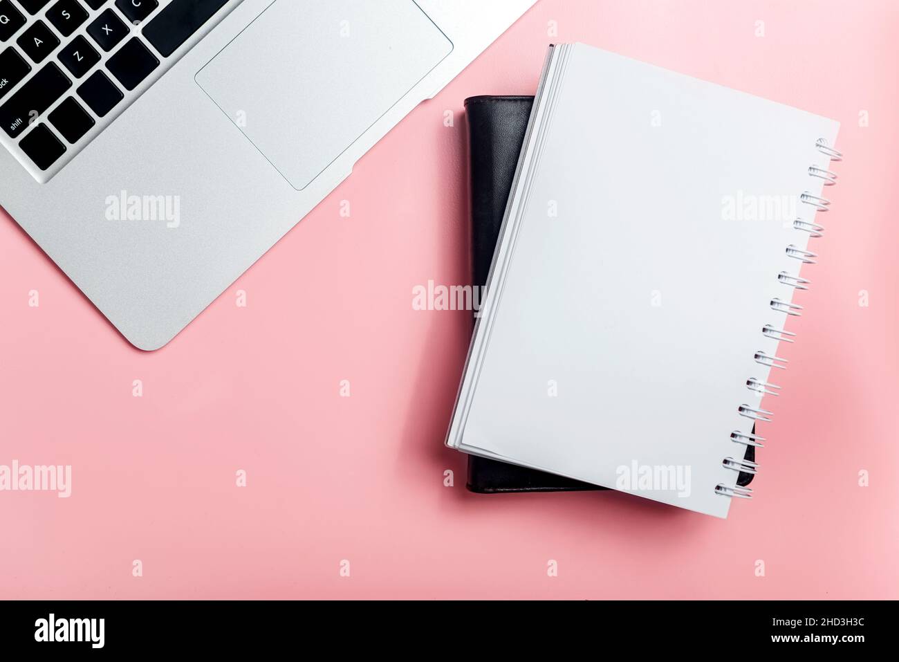 Laptop and note book with colored background Stock Photo - Alamy
