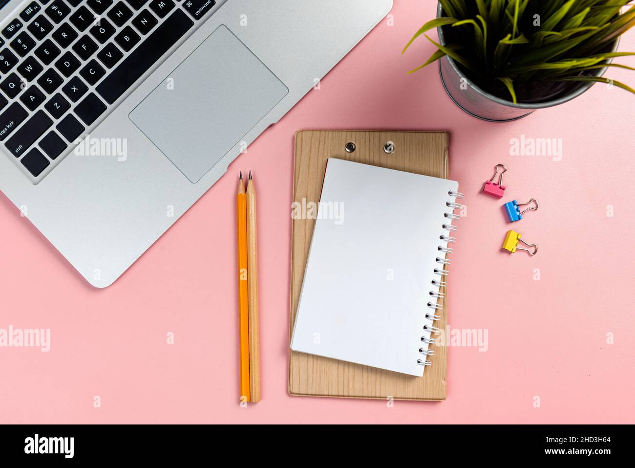 Laptop and note book with pencil with colored background Stock Photo ...