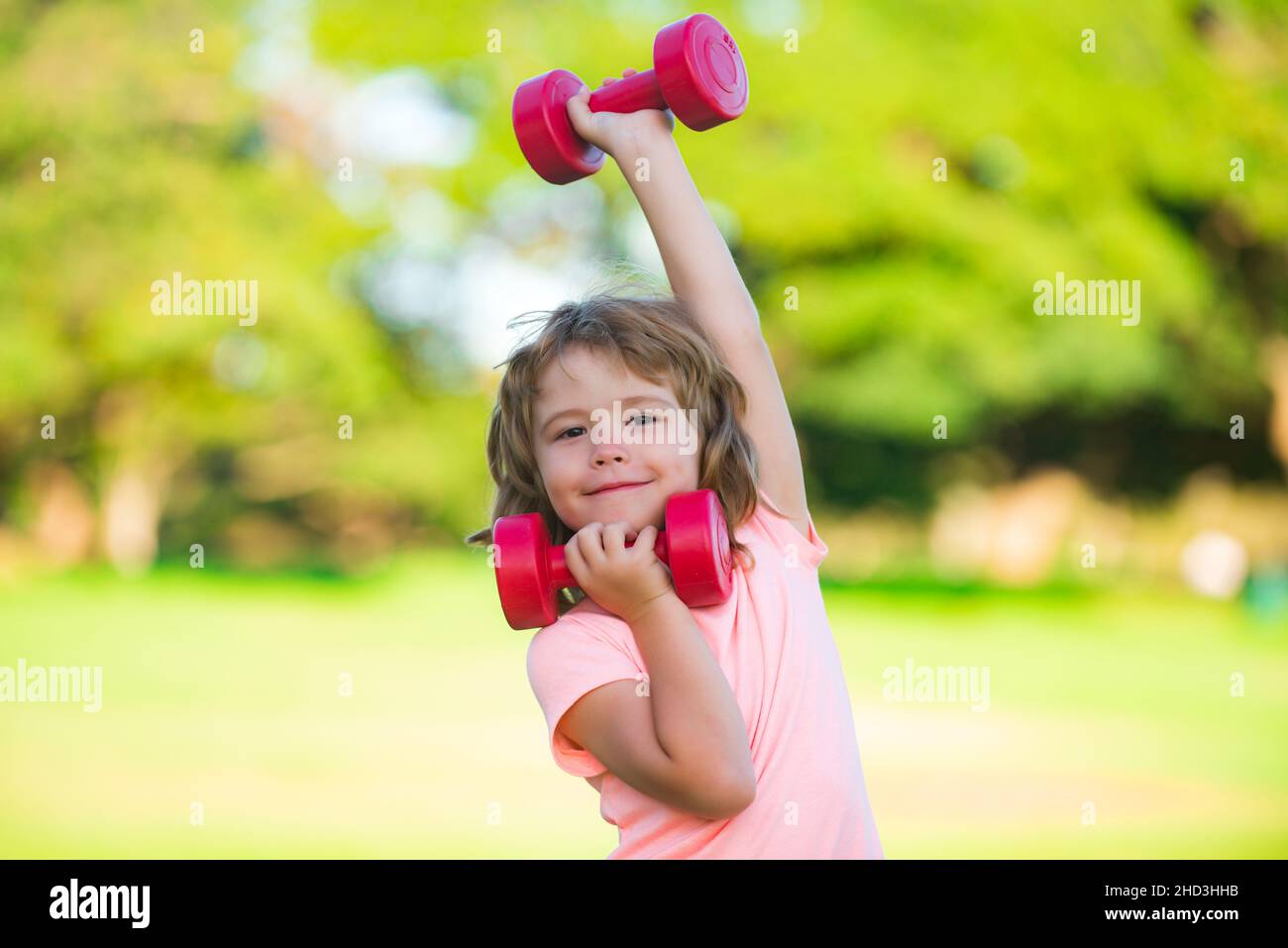 Fitness dumbbells kid exercise workout outdoor. Boy sporty child with ...