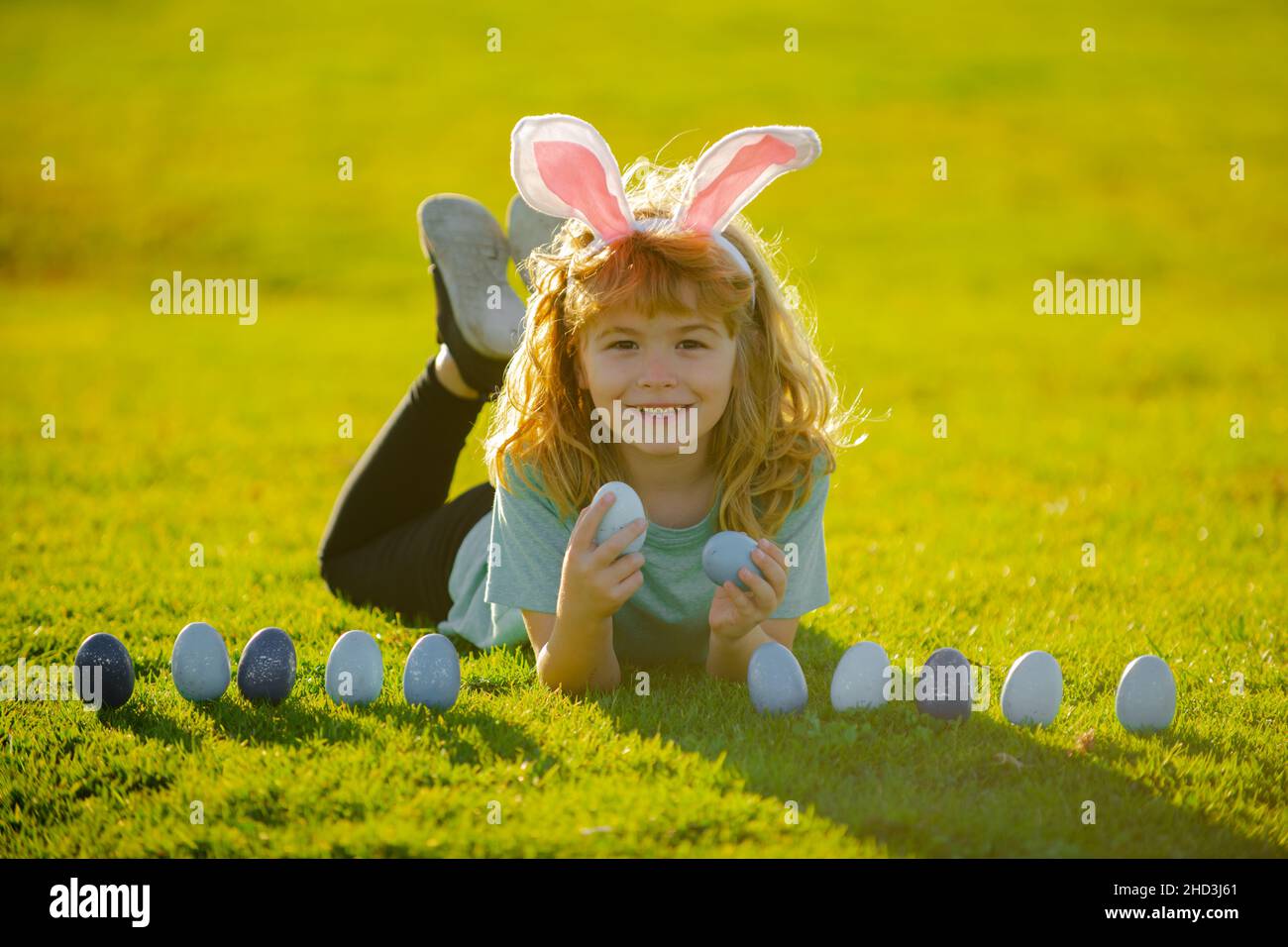 Kids on Easter egg hunt in garden. Children with colorful eggs in grass ...