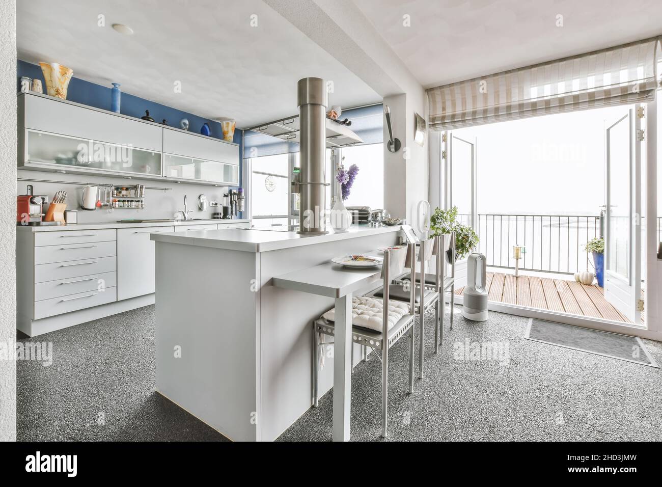 Nice kitchen with a cupboard on the wall and large windows Stock Photo ...