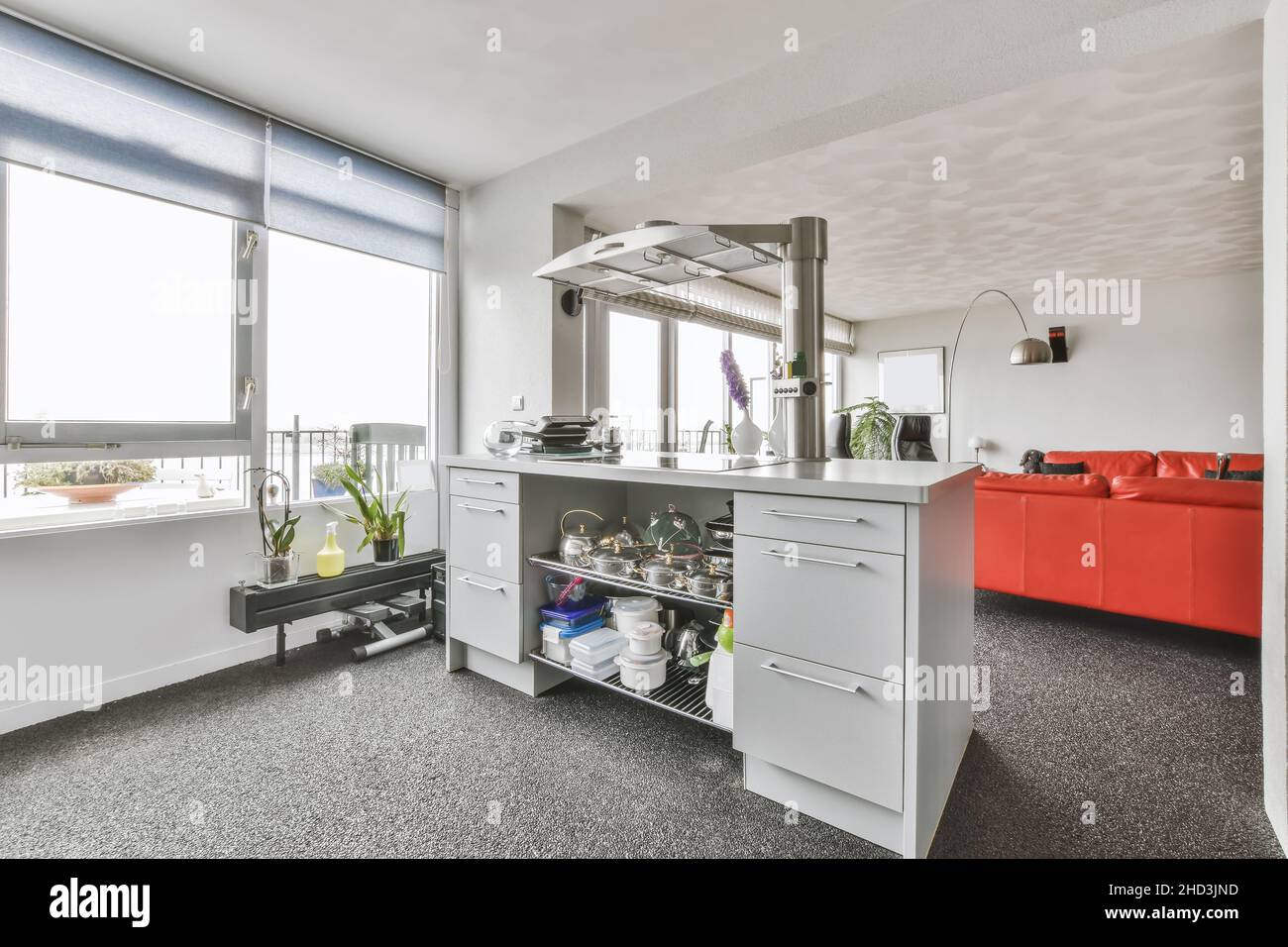 Nice kitchen with a table in the middle and a modern range hood above ...