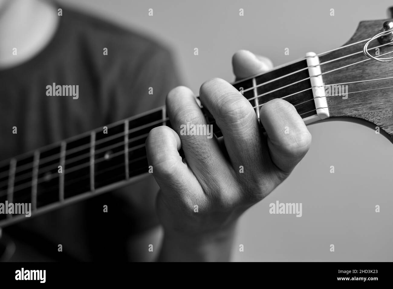 Men catch chords are learning to play guitar. Closeup musicians are ...