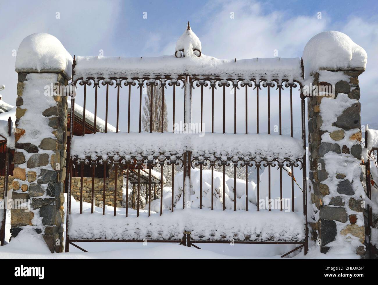 wrought iron gate covered with snow of an alpine house Stock Photo - Alamy