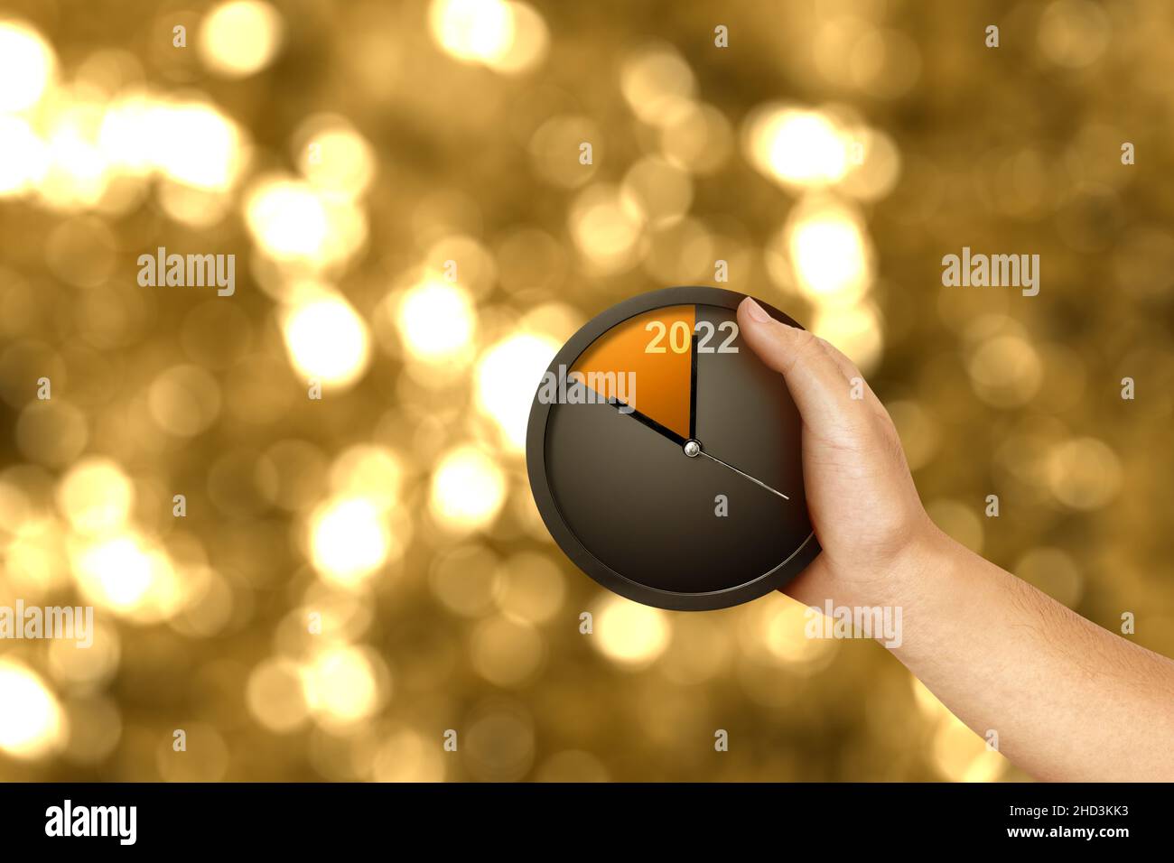 Human hand holding a clock waiting for 2022. Happy New Year 2022 Stock ...