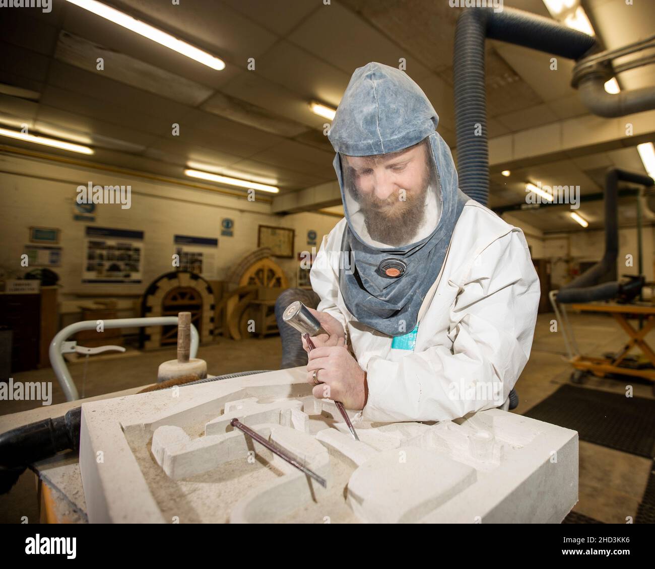 Banker Mason Stephen Hamilton carving a piece of stone. A pilot project ...