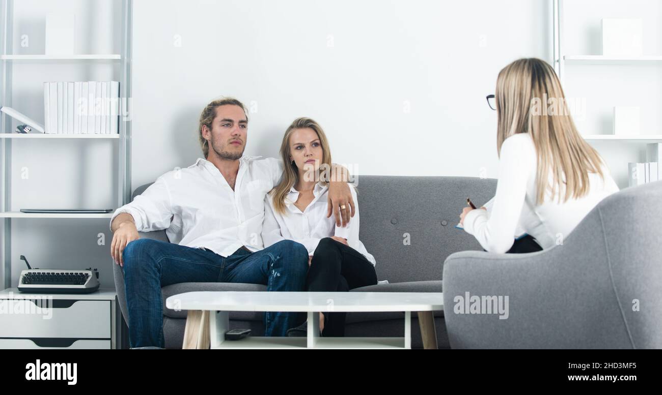 Couple discussing problems in family with social worker or family ...