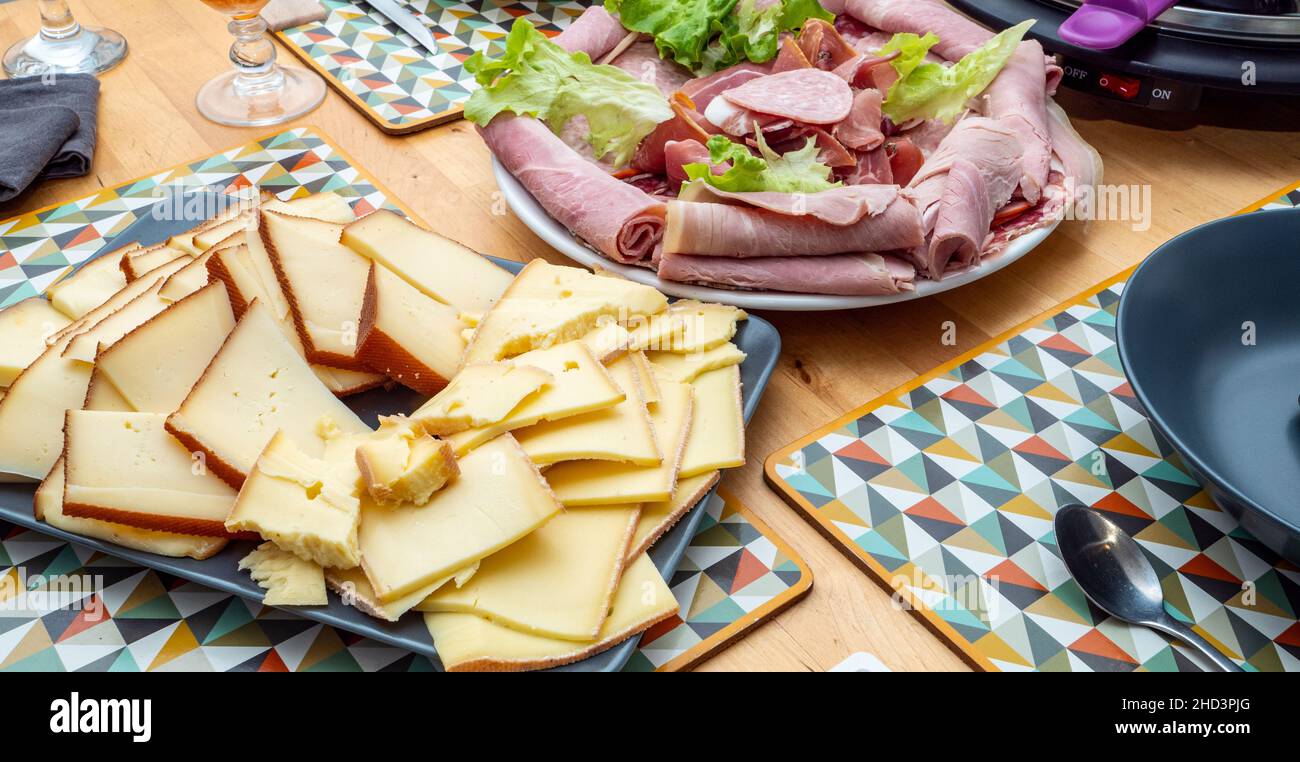 Raclette cheese and meat, a french tradition Stock Photo - Alamy