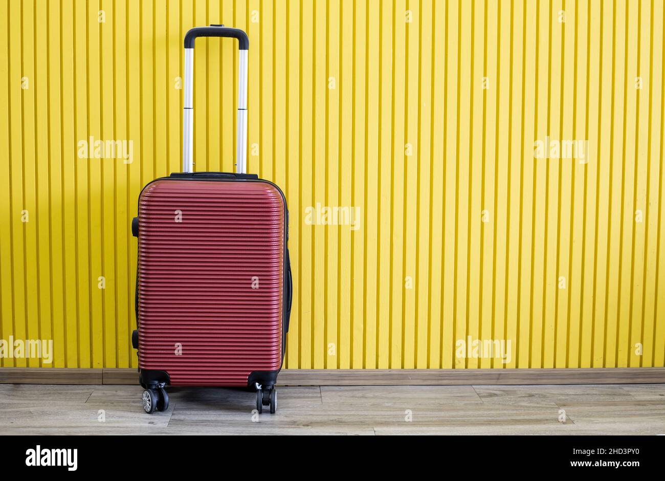Travel concept, big red suitcase on a wooden floor and have a yellow ...