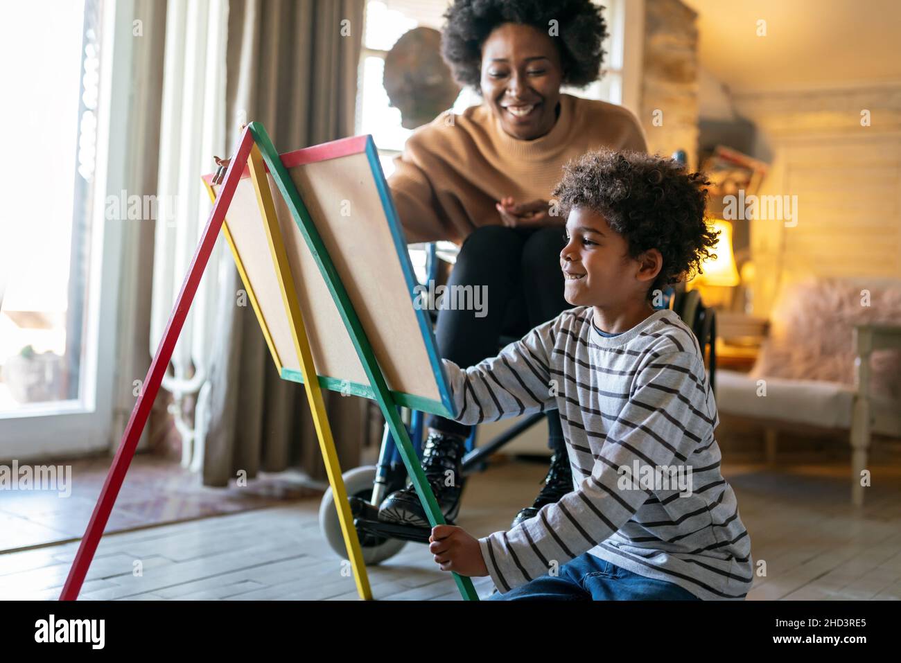 Happy child doing math exercises with her mother ot teacher together ...