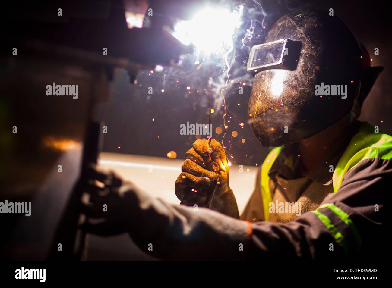 Man works on metal welding steel using electric welding machine to weld ...