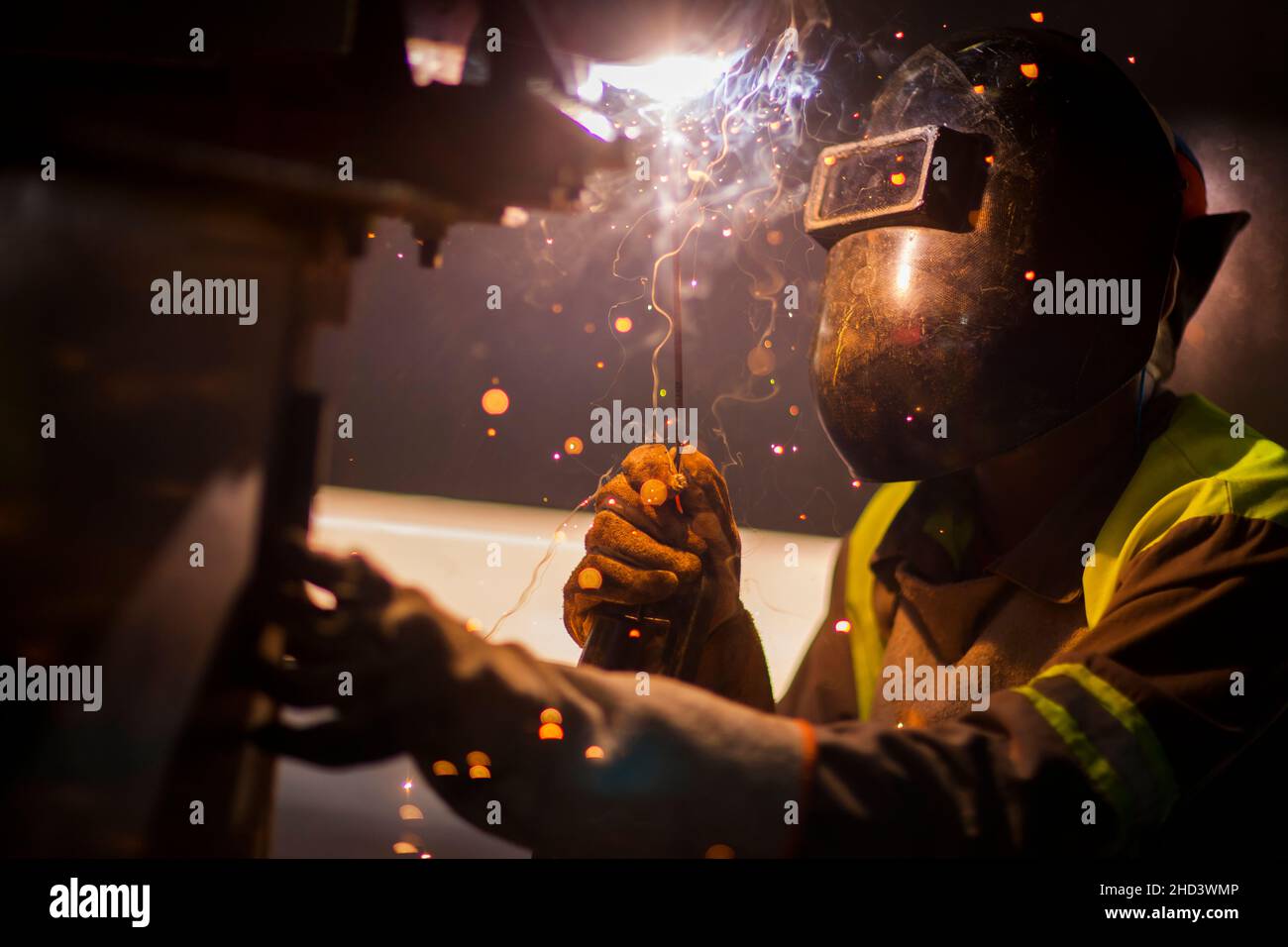 Man works on metal welding steel using electric welding machine to weld ...