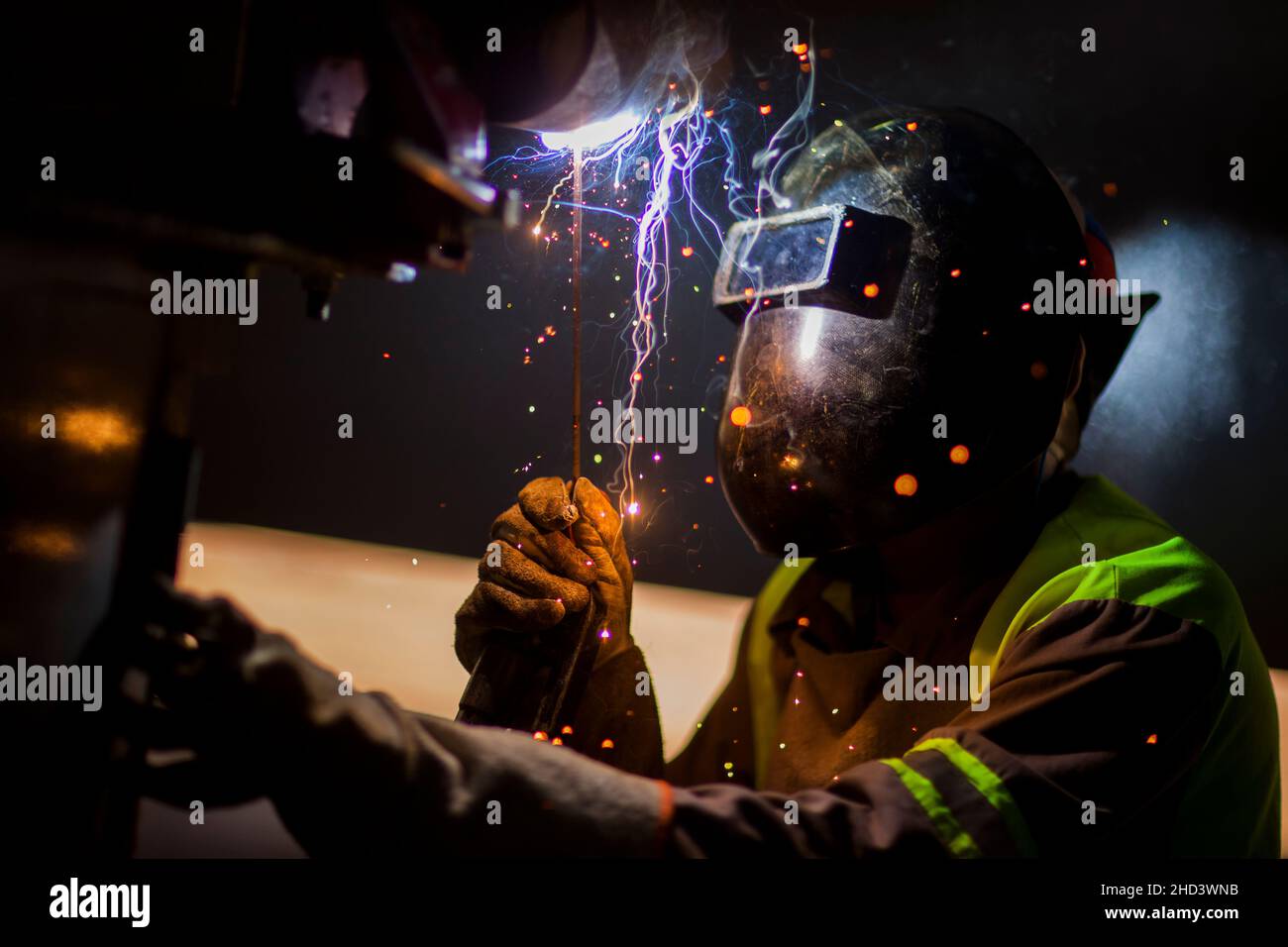 Man works on metal welding steel using electric welding machine to weld ...