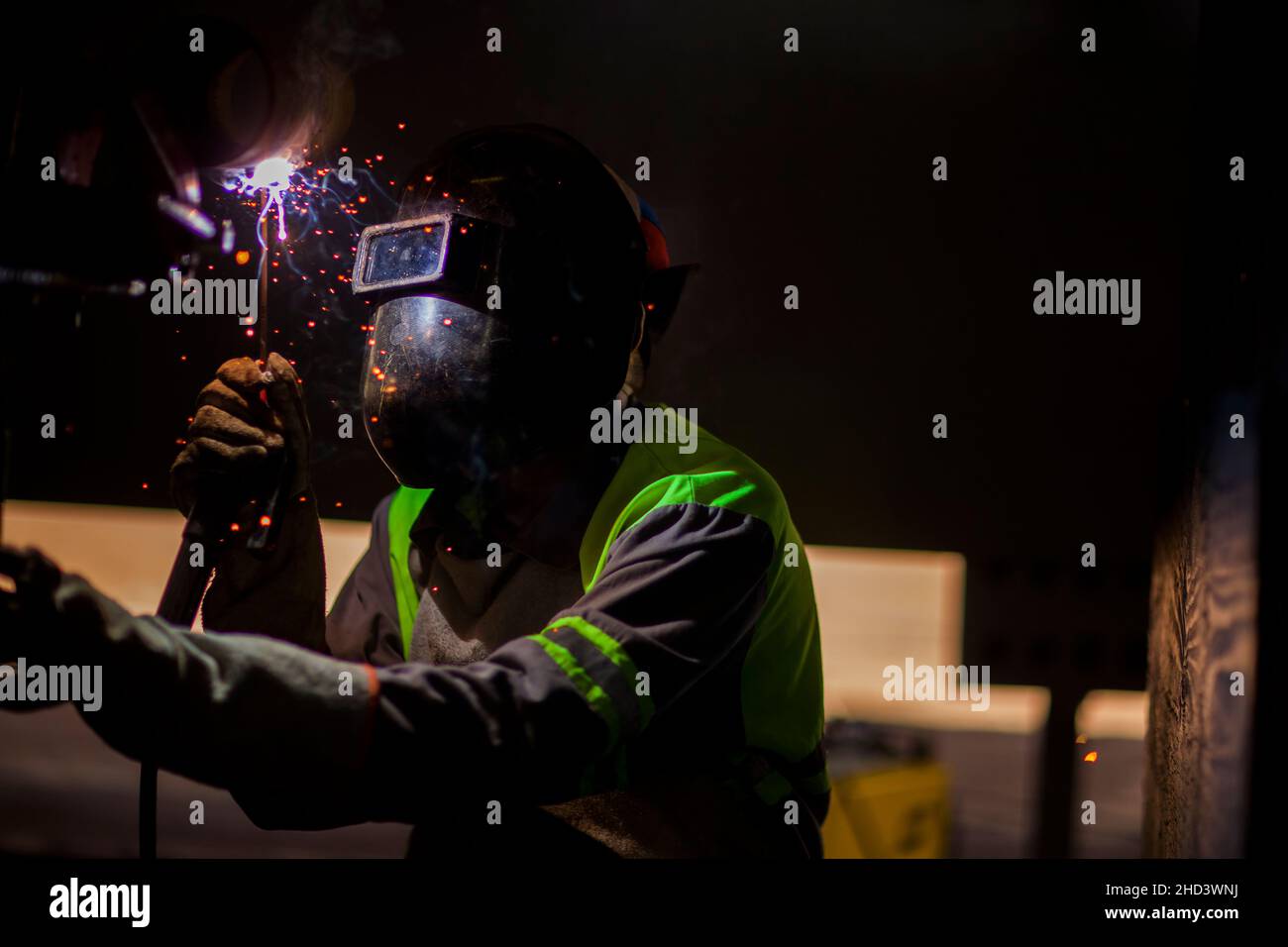 Man works on metal welding steel using electric welding machine to weld ...