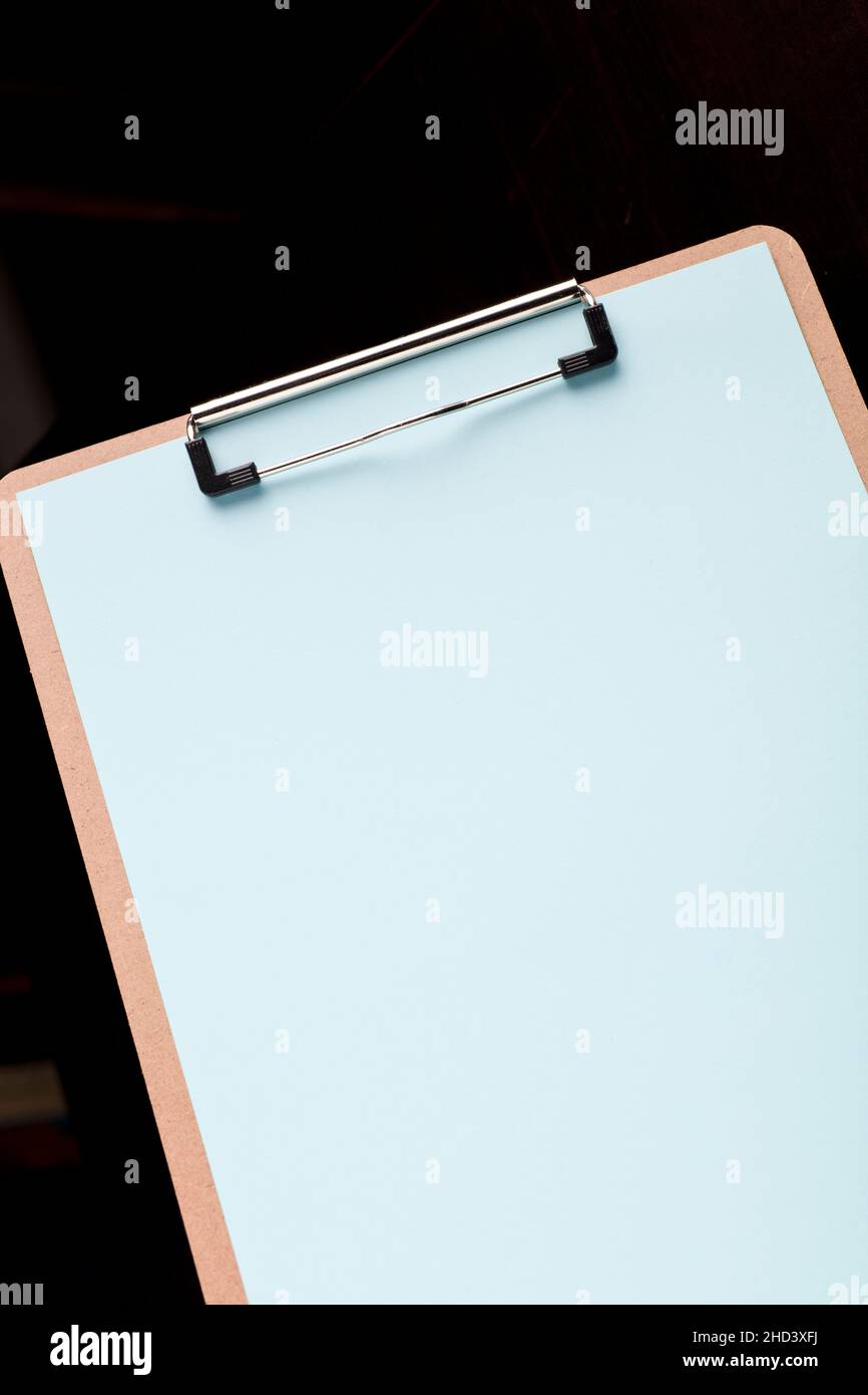 notepad with blue sheet and black background Stock Photo - Alamy