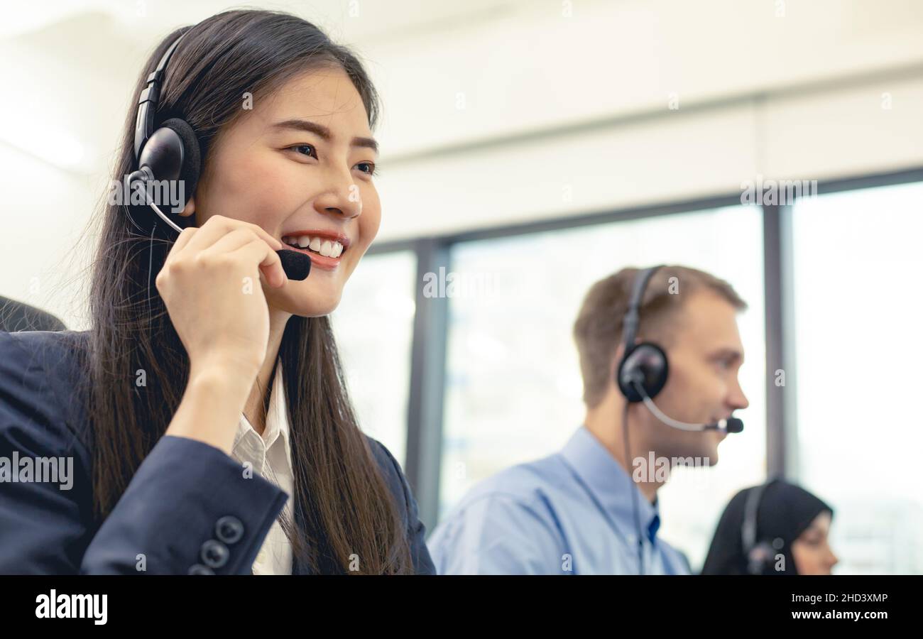Beautiful Asian woman and group of diverse telemarketing customer ...