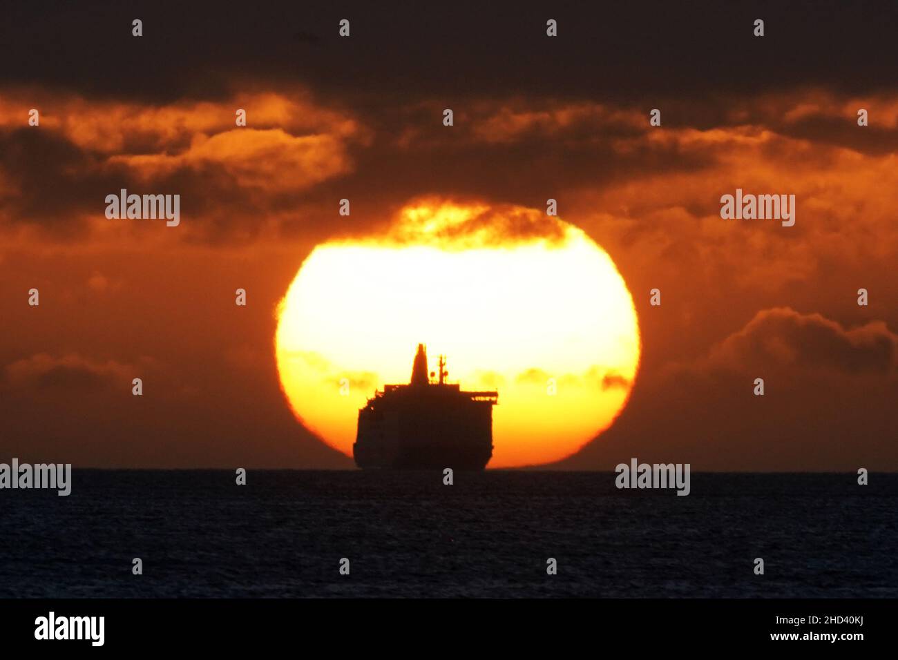 The Princess Seaways ferry sails along the horizon as the sun rises at ...