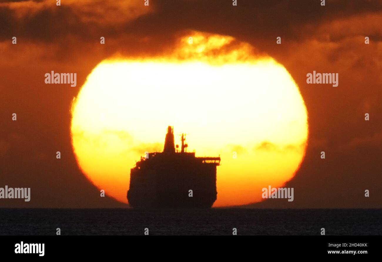 The Princess Seaways ferry sails along the horizon as the sun rises at ...