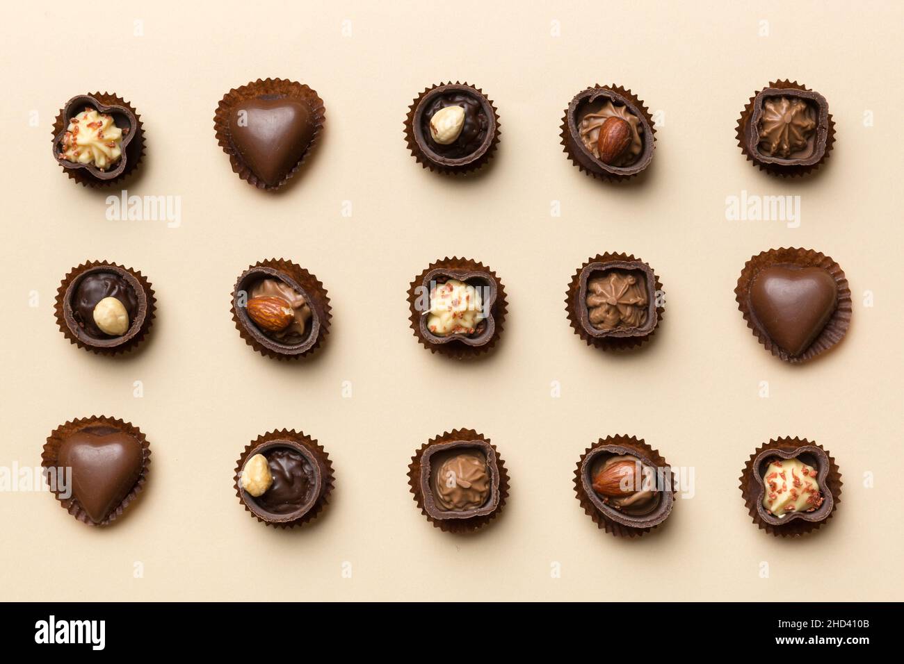 Different kinds of chocolates on colored table close-up. Top View and ...