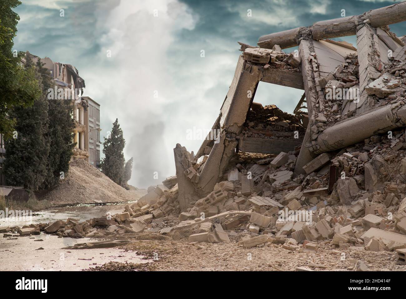 View on a collapsed concrete industrial building with white smoke ...