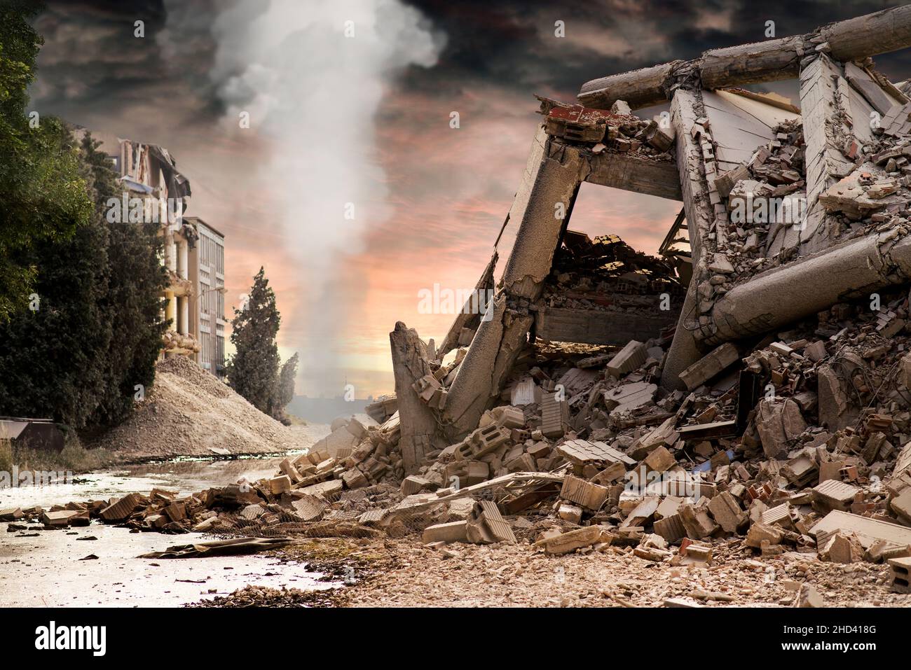 View on a collapsed concrete industrial building with white smoke ...