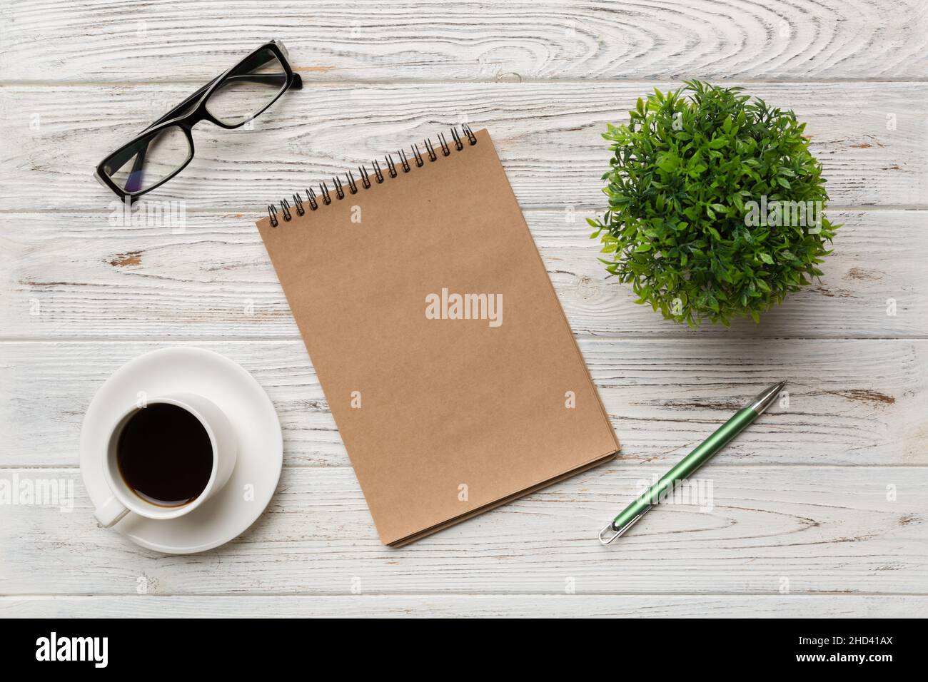 Modern office desk table with notebook and other supplies with cup of ...