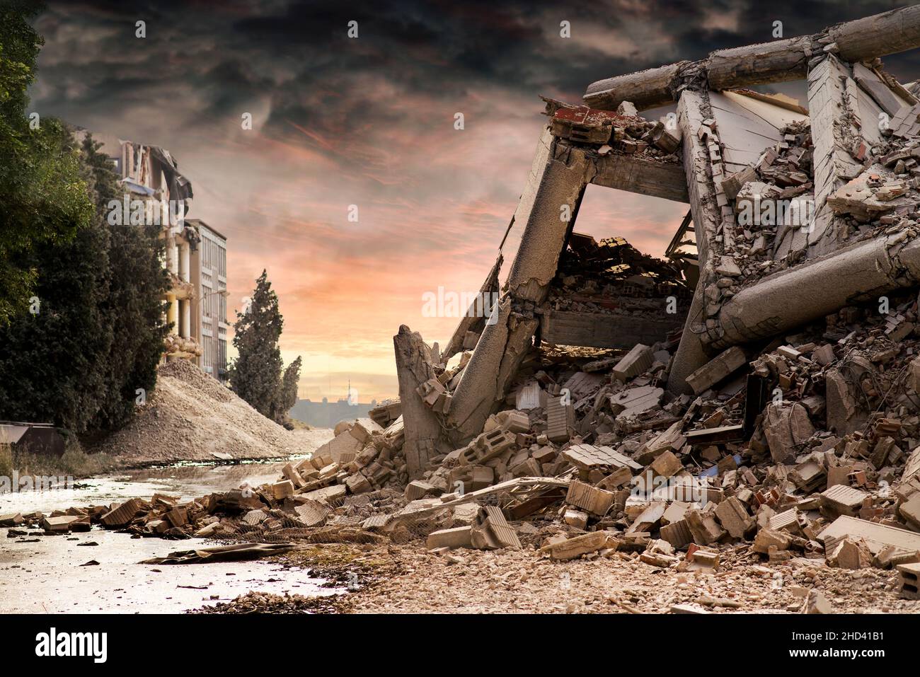 View on a collapsed concrete industrial building with dark red dramatic ...