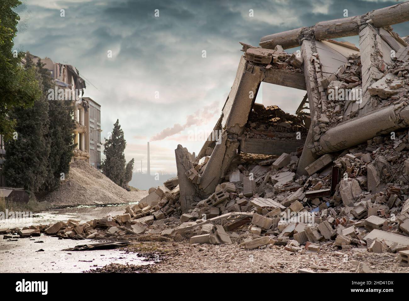 View on a collapsed concrete industrial building with smoking factory ...