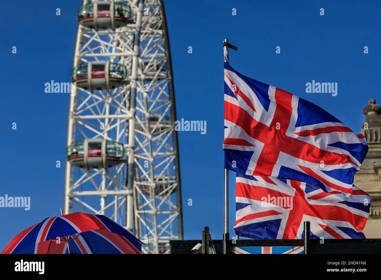 British Union Jack Flags with the London Eye ferris wheel against blue ...