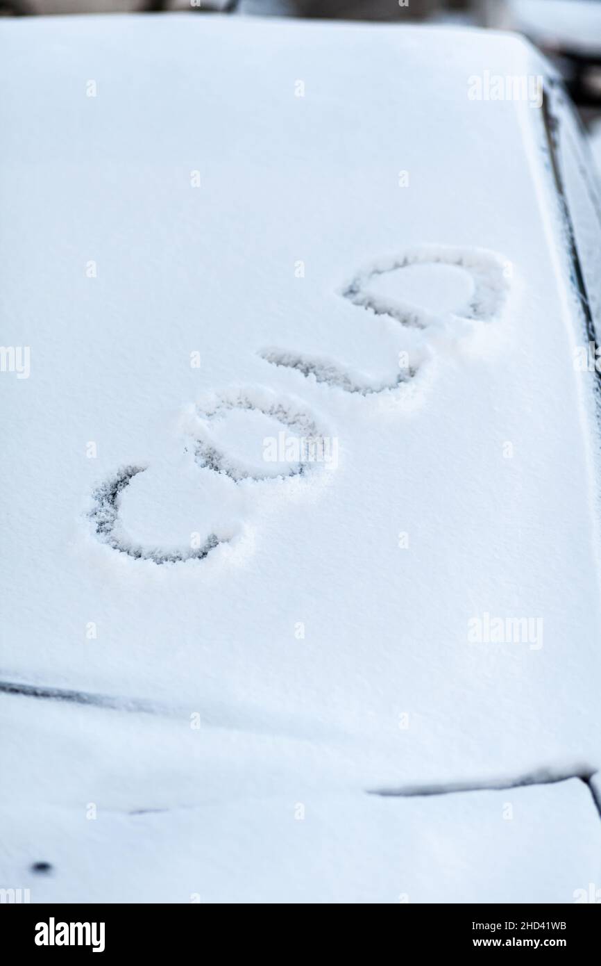 The word cold written on a frozen car screen. Cold written on front ...